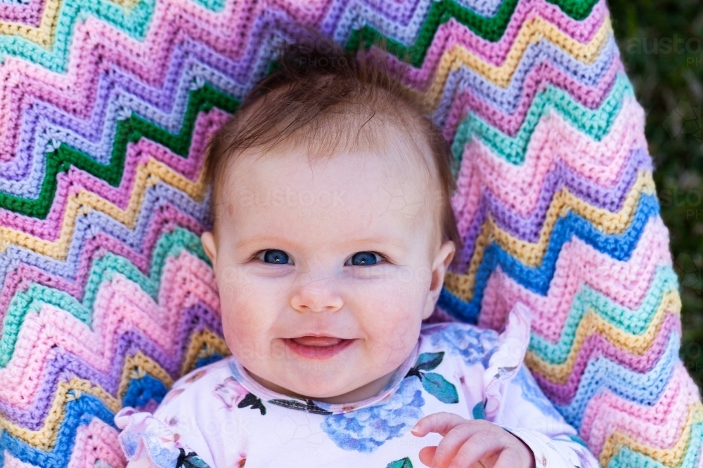 Image of happy baby girl portrait sitting in bouncer smiling - Austockphoto