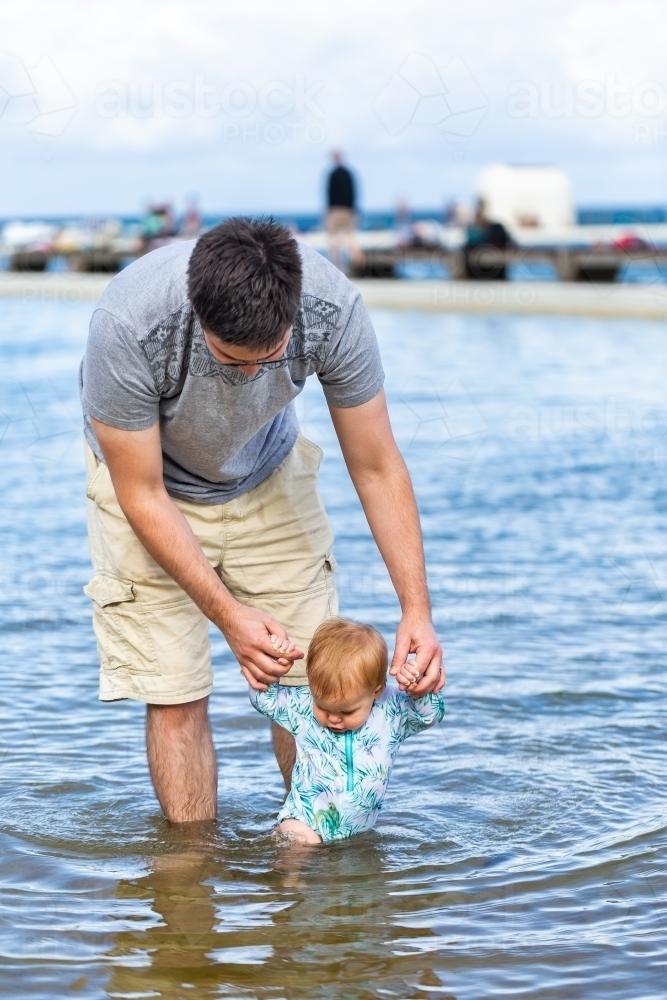 Image of Happy child with dad in sea water in ocean pool at first trip ...