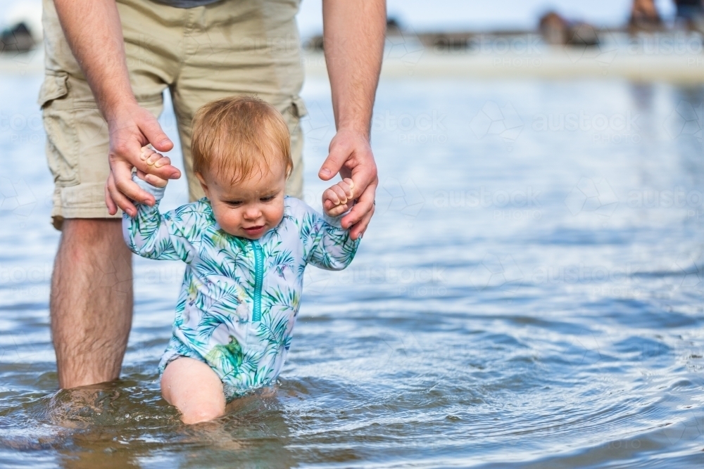Image of Happy child with dad in sea water in ocean pool at first trip ...