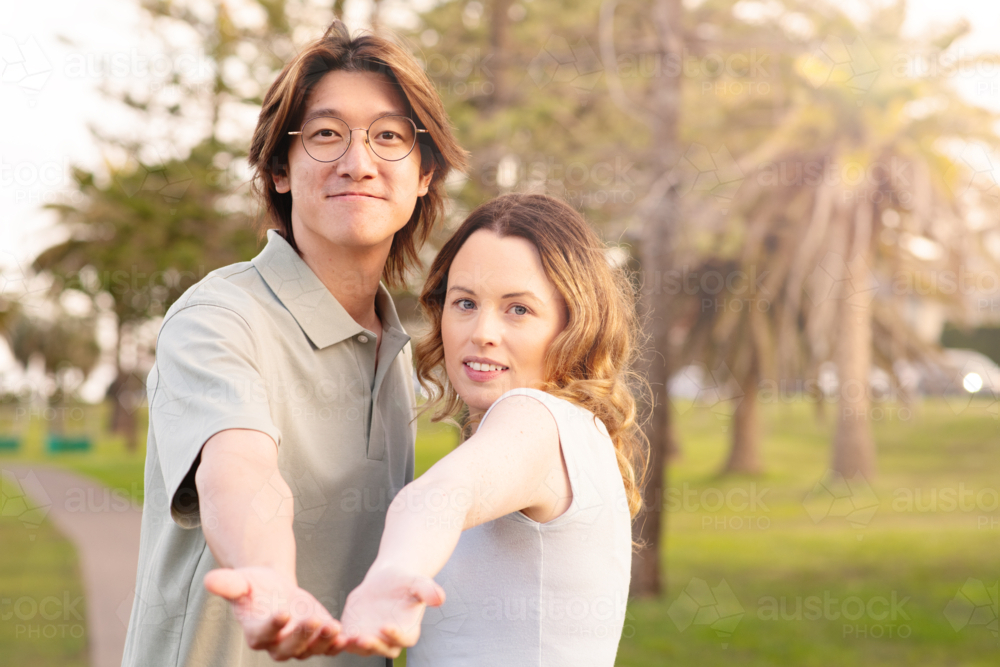 Image of happy couple posing in the park - Austockphoto