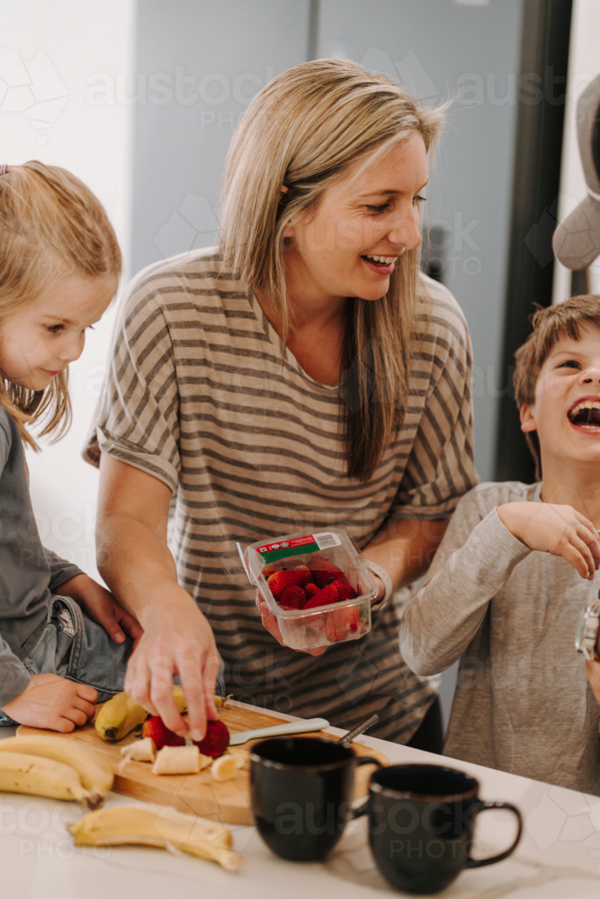 Image of Happy family helping each other prepare food in the kitchen ...