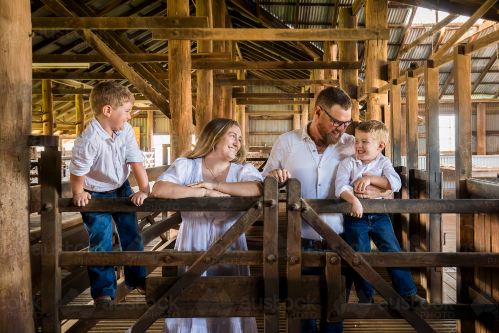 Image of Happy family of four in rustic Australian shearing shed on ...