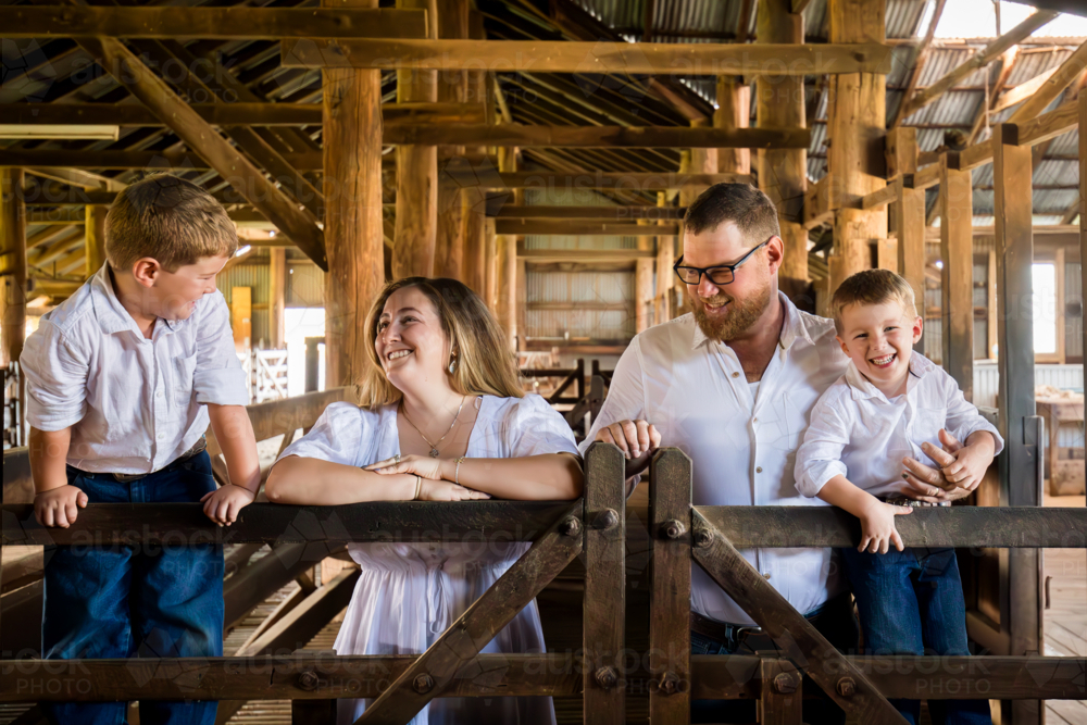 Image of Happy family of four in rustic Australian shearing shed on ...