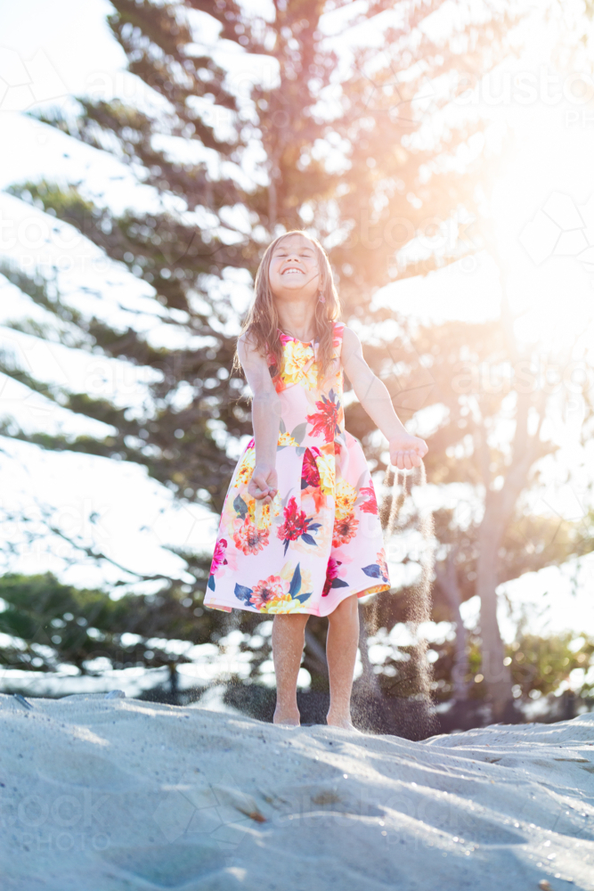 Image of Happy First Nations Australian little girl throwing sand in ...