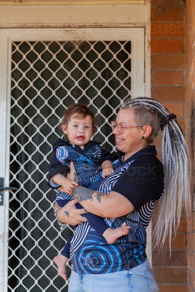 Image of Happy first nations Australian parent with baby girl on front ...