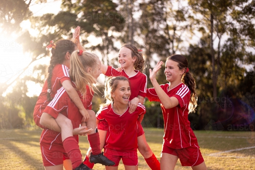 Image of Happy football team of tween girls celebrating together ...
