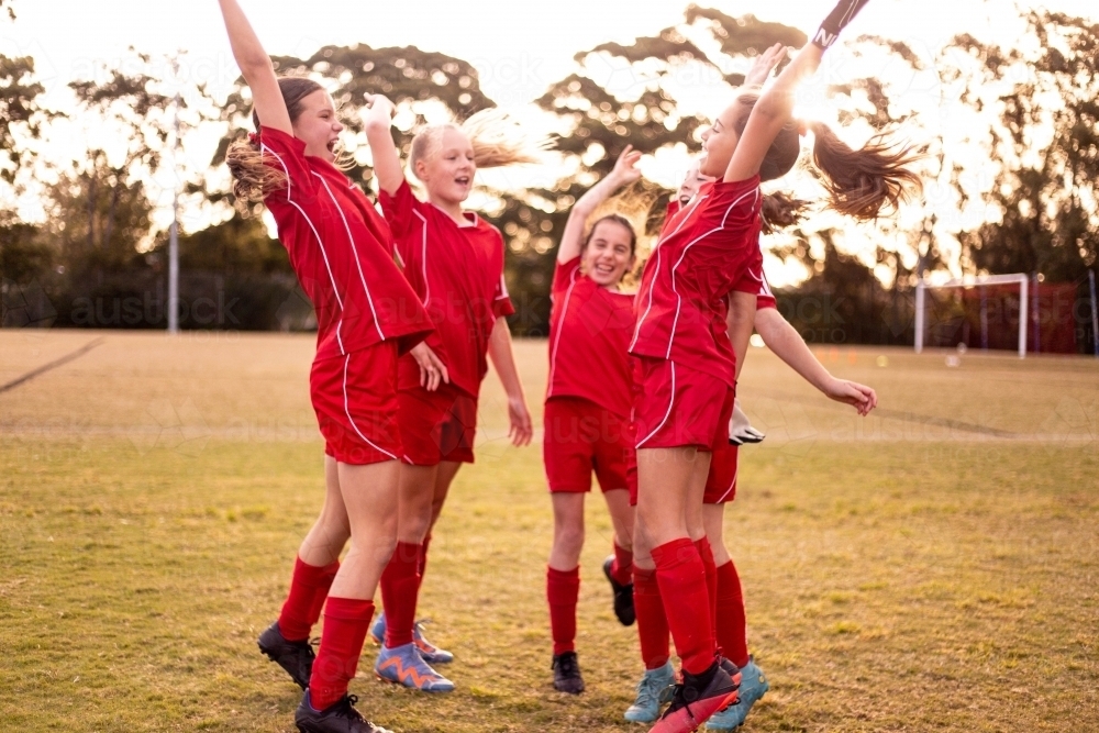 Image of Happy football team of tween girls celebrating together ...