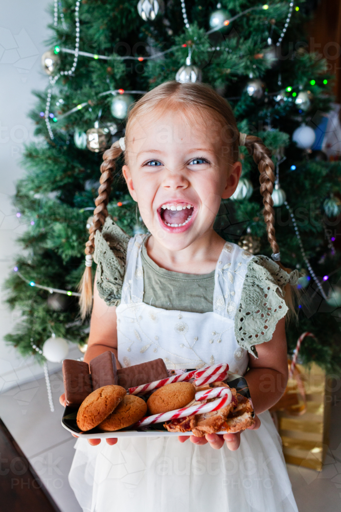 Image of Happy little girl with plate of candy canes and homemade ...