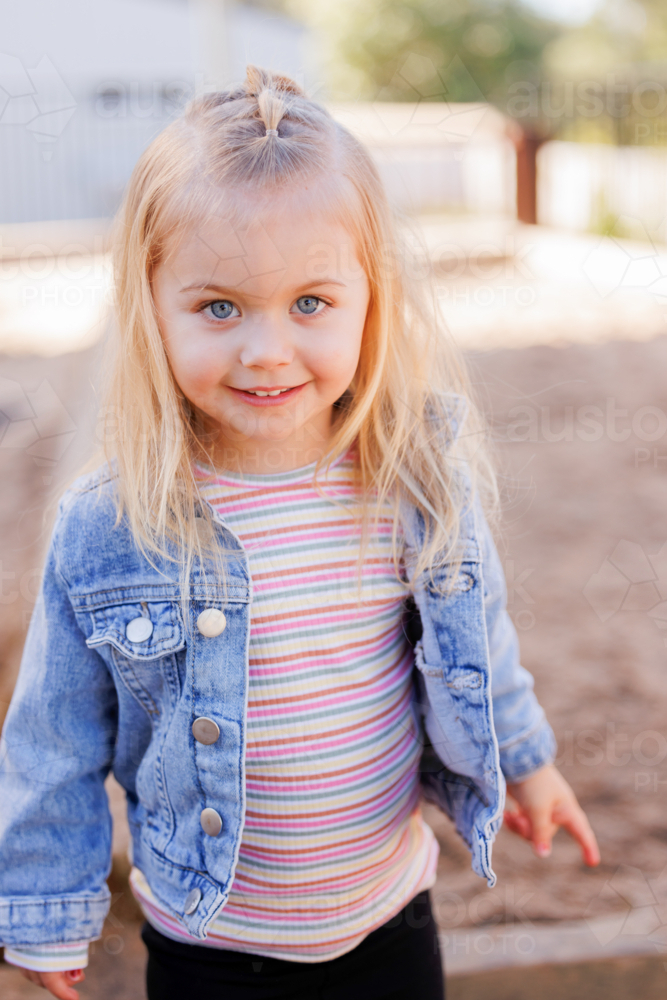 Image of Happy little preschool girl smiling at kindergarten - Austockphoto