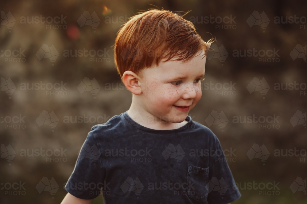 Image of Happy little red head boy exploring the Australian bush ...