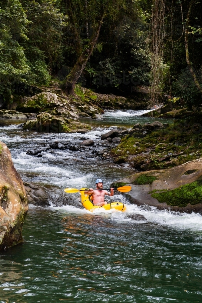 Image of Happy man shooting the rapids on Allyn River in an inflatable ...