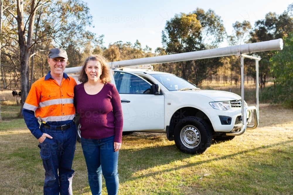 Image of Happy middle aged Aussie couple infront of work ute for start ...