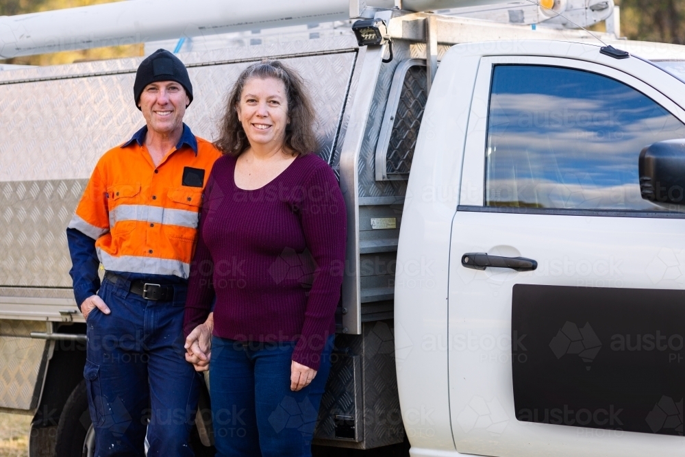 Image of Happy middle aged Aussie couple infront of work ute for start ...