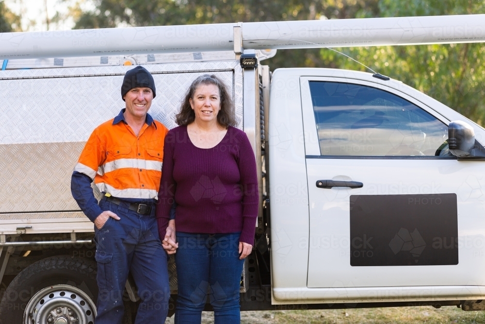 Image of Happy middle aged Aussie couple infront of work ute for start ...