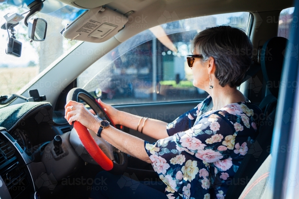 Image of Happy middle aged driver in car with sunnies on - Austockphoto