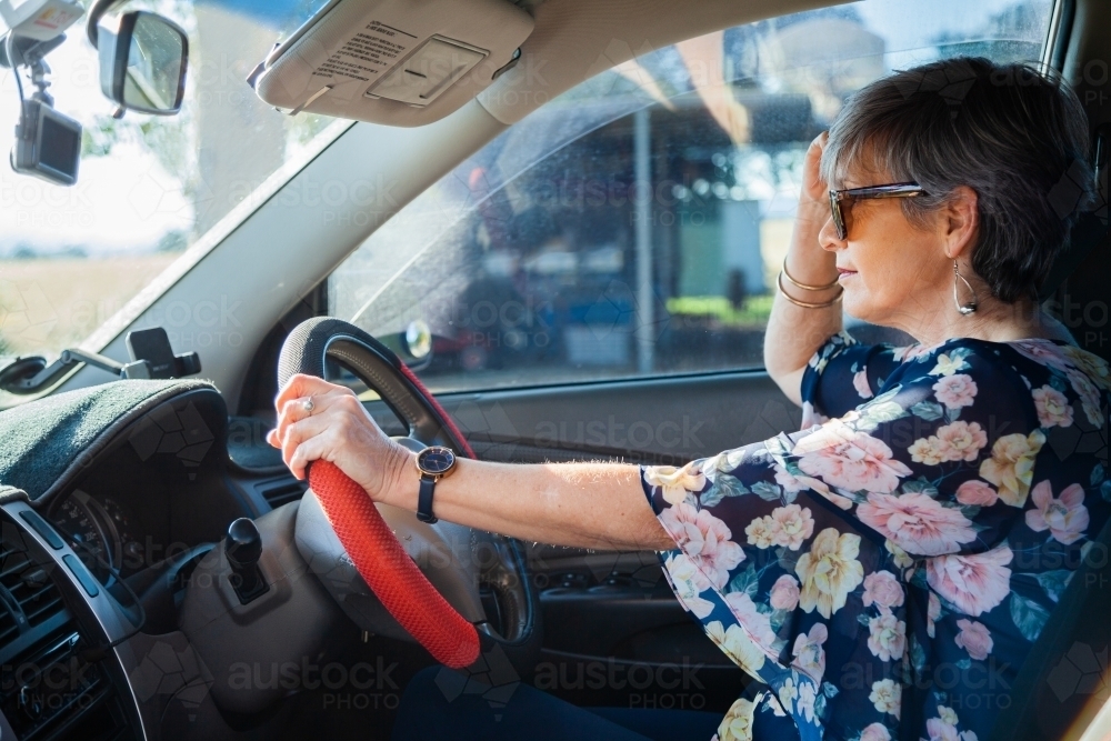 Image of Happy middle aged driver in car with sunnies on - Austockphoto