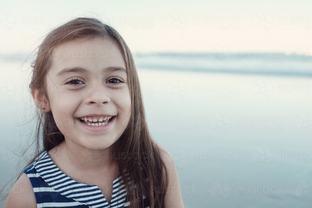 Image of Happy multicultural young little girl on the beach - Austockphoto