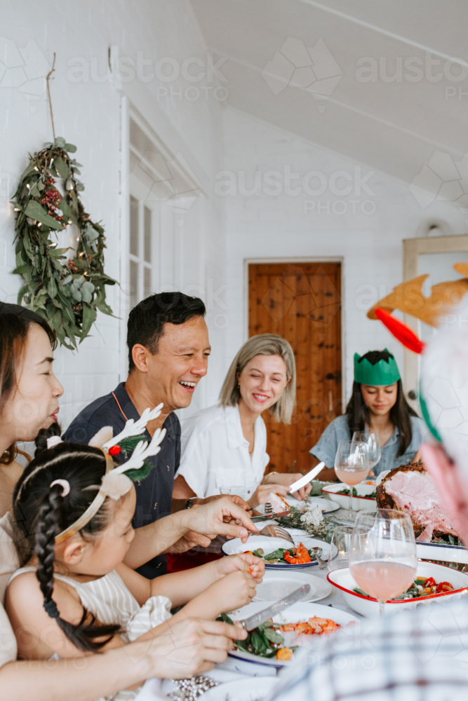 Image of Happy multiracial family enjoying Christmas dinner - Austockphoto