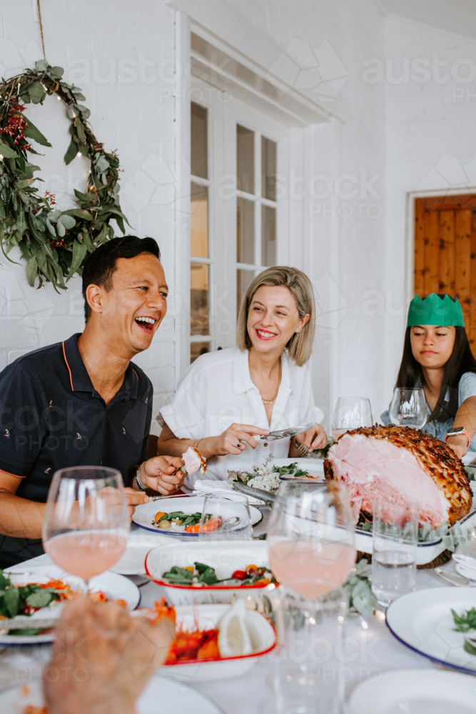 Image of Happy multiracial family enjoying Christmas dinner - Austockphoto