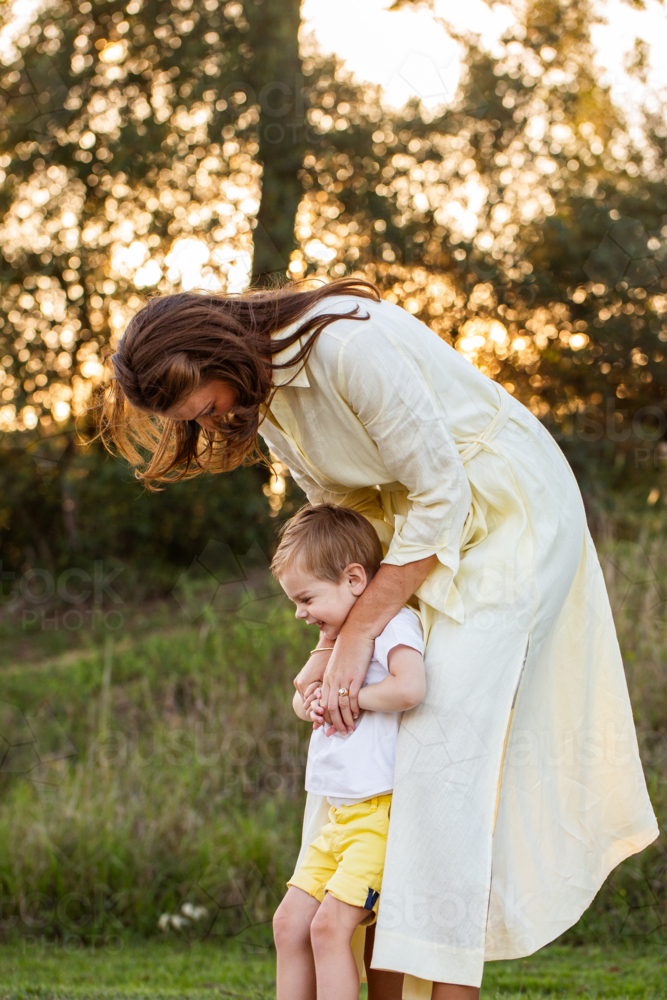 Image of Happy mum and son together in nature at sunset with bokeh ...