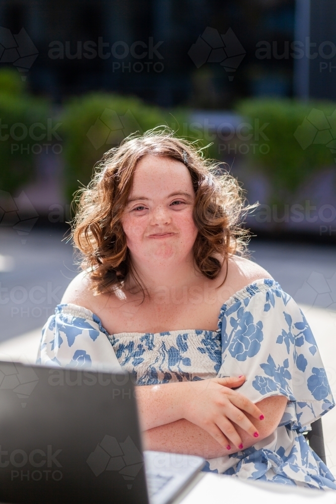 Image of Happy portrait of young person with a disability sitting at ...