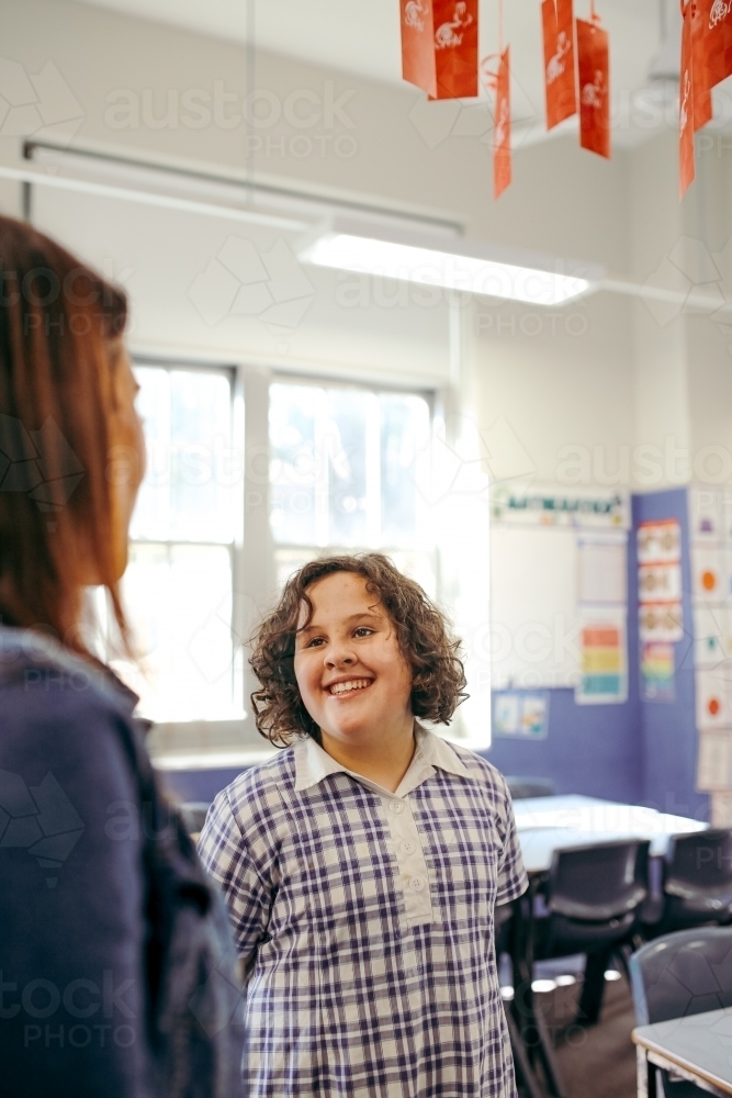 Image of Happy primary school student in classroom with teacher ...