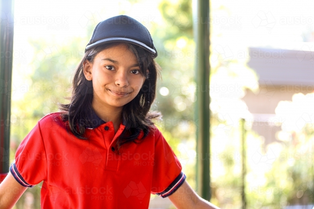Image of Happy primary school student wearing a cap - Austockphoto