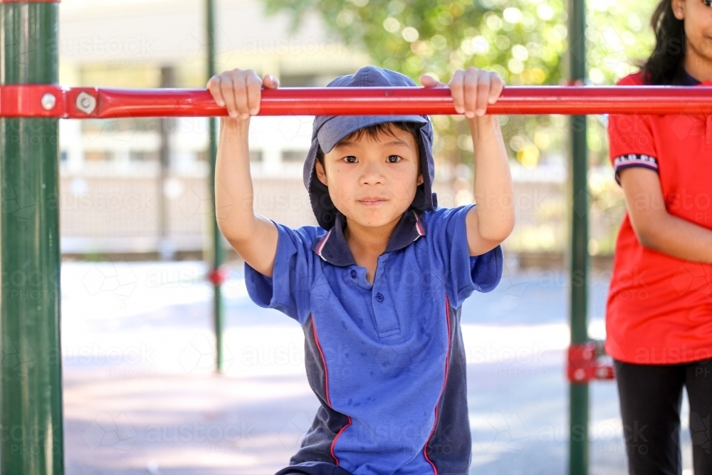 Image of Happy primary school student with play equipment looking at ...