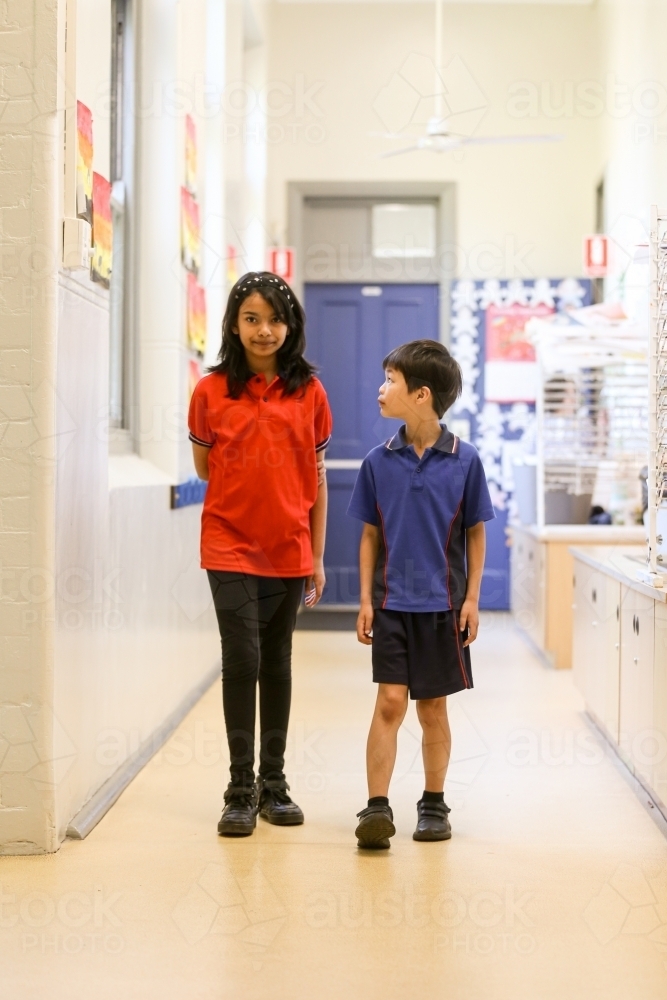 Image of Happy primary school students together in hallway at school ...