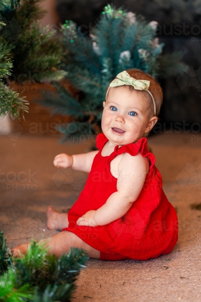 Image of happy seven month old baby sitting on floor near Christmas ...