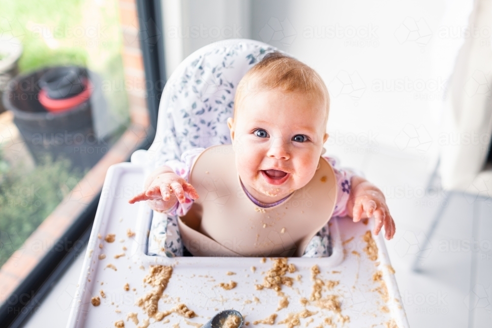 Image Of Happy Six Month Old Baby Enjoying Baby Led Weaning Making Mess image-of-happy-six-month-old-baby-enjoying-baby-led-weaning-making-mess