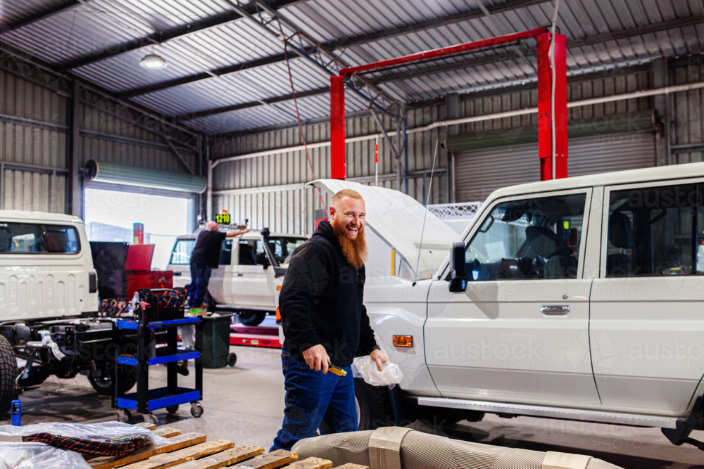 Image of Happy smiling australian mechanic in industrial workshop shed ...