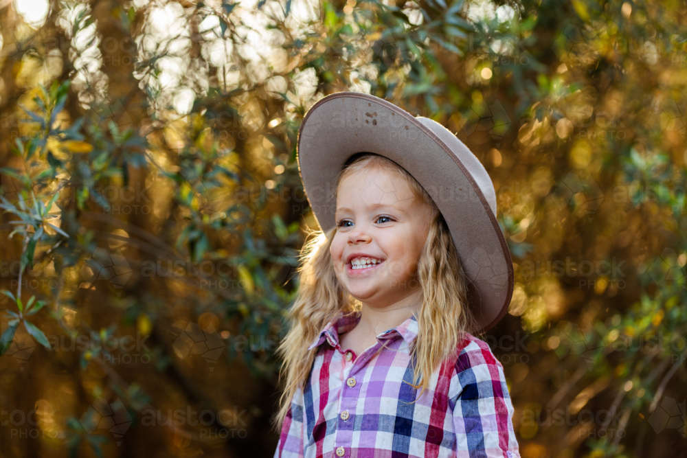 Image of Happy smiling country kid in mud splattered Australian bush ...