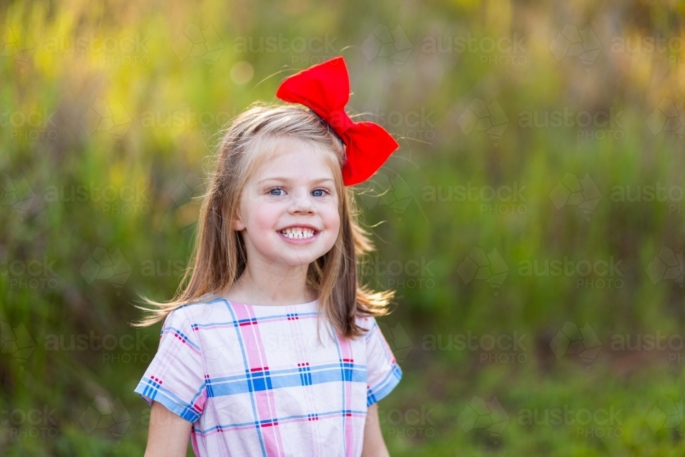 Image of Happy smiling young child outside at park with hidden ...