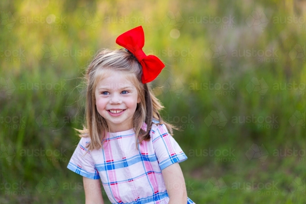 Image of Happy smiling young child outside at park with hidden ...