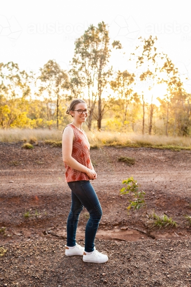 Image of Happy smiling young person standing outside on summer evening ...