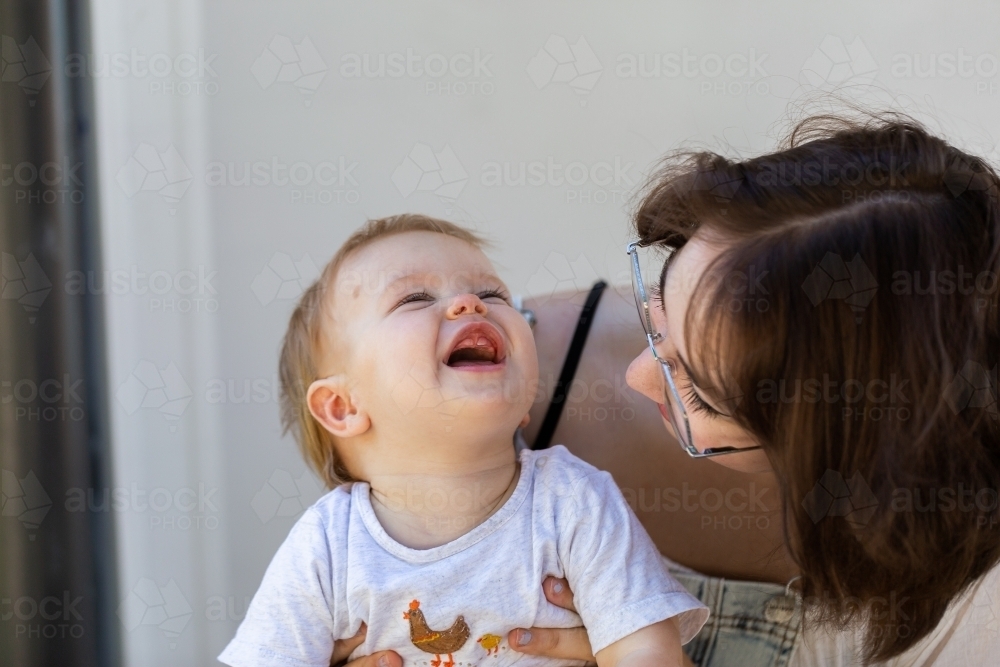 Image of happy ten month old baby laughing with aunty outside ...