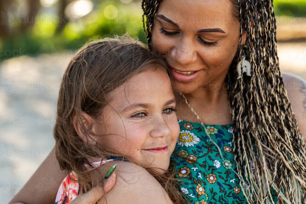 Image of Happy Torres Strait Islander woman holding her nine year old ...