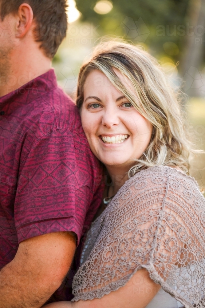 Image of Happy twenty-something woman embracing partner in golden ...