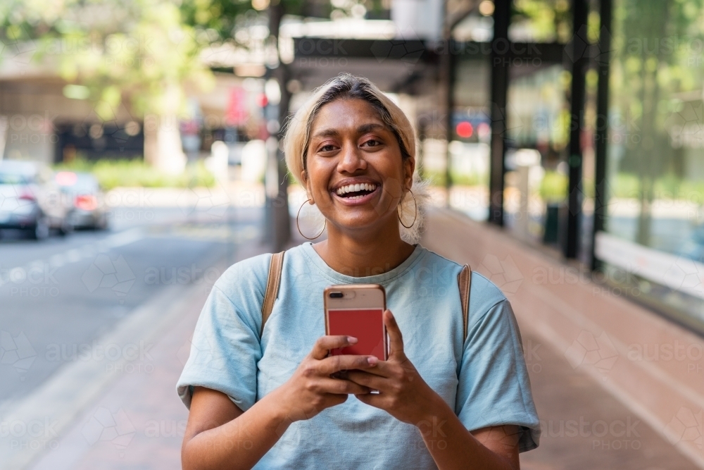 Image of woman using phone - Austockphoto