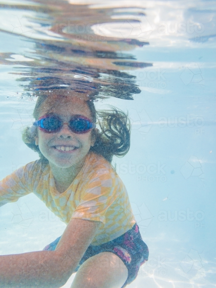 Image of Happy young aussie girl swimming in pool underwater in summer ...