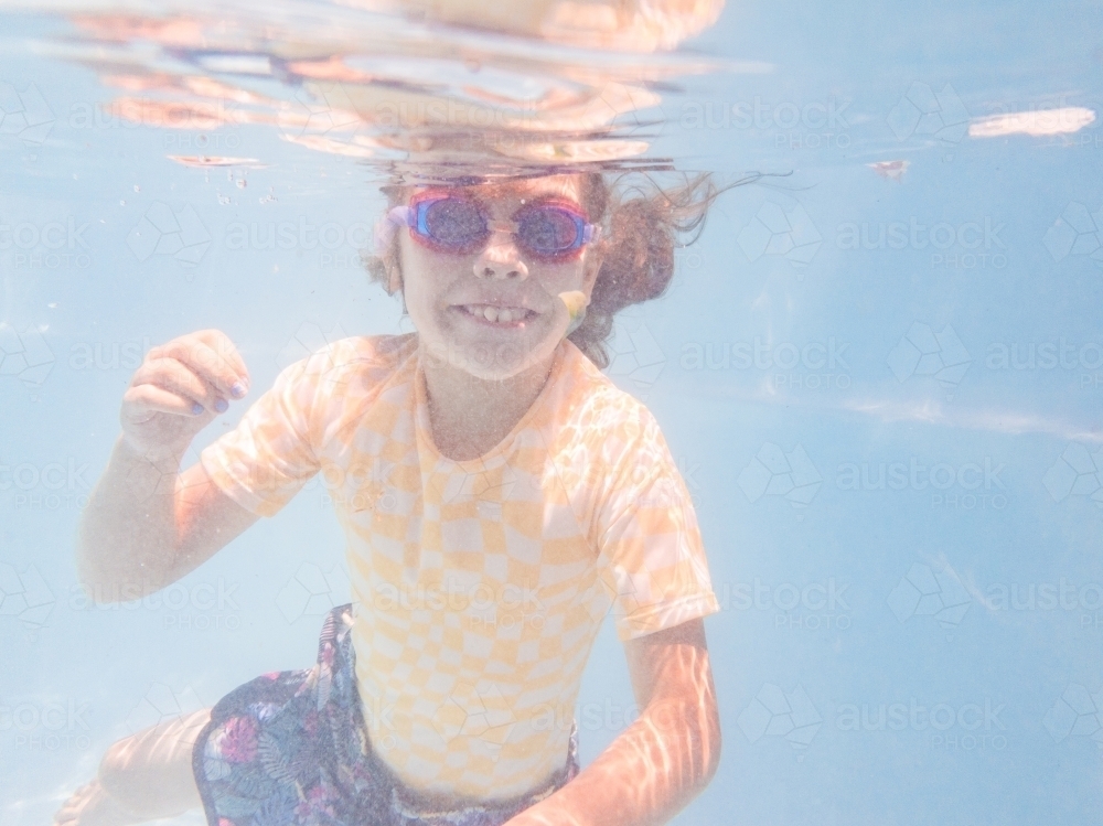 Image of Happy young aussie girl swimming in pool underwater in summer ...