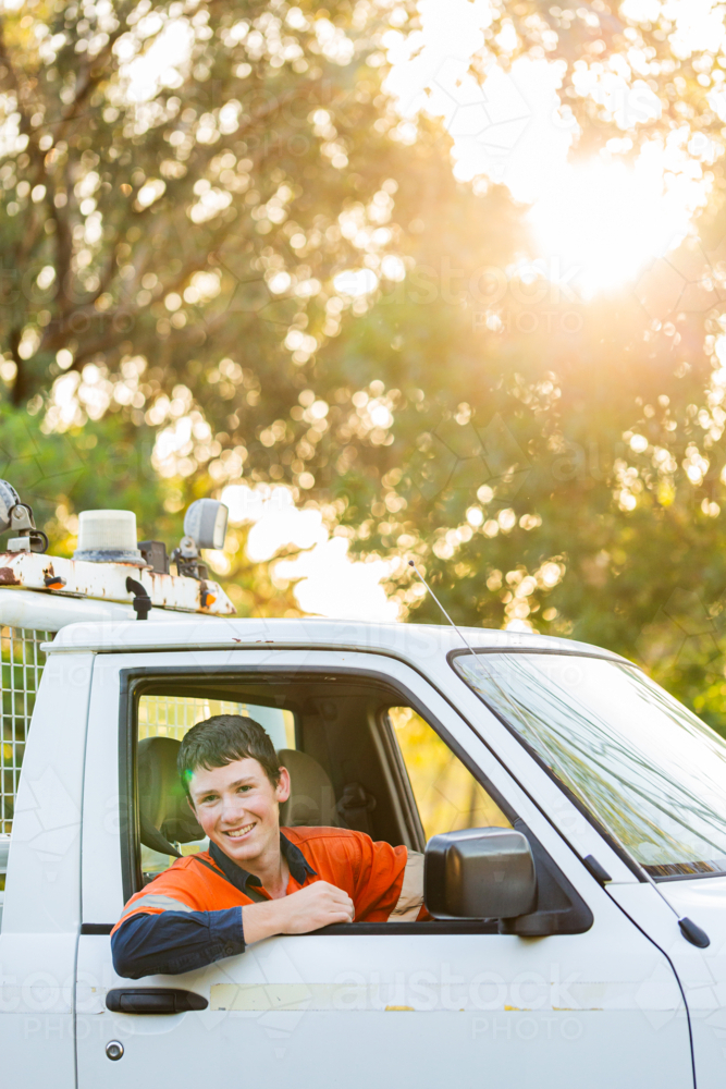 Image of Happy young Aussie teenager driving ute on Australian farm ...