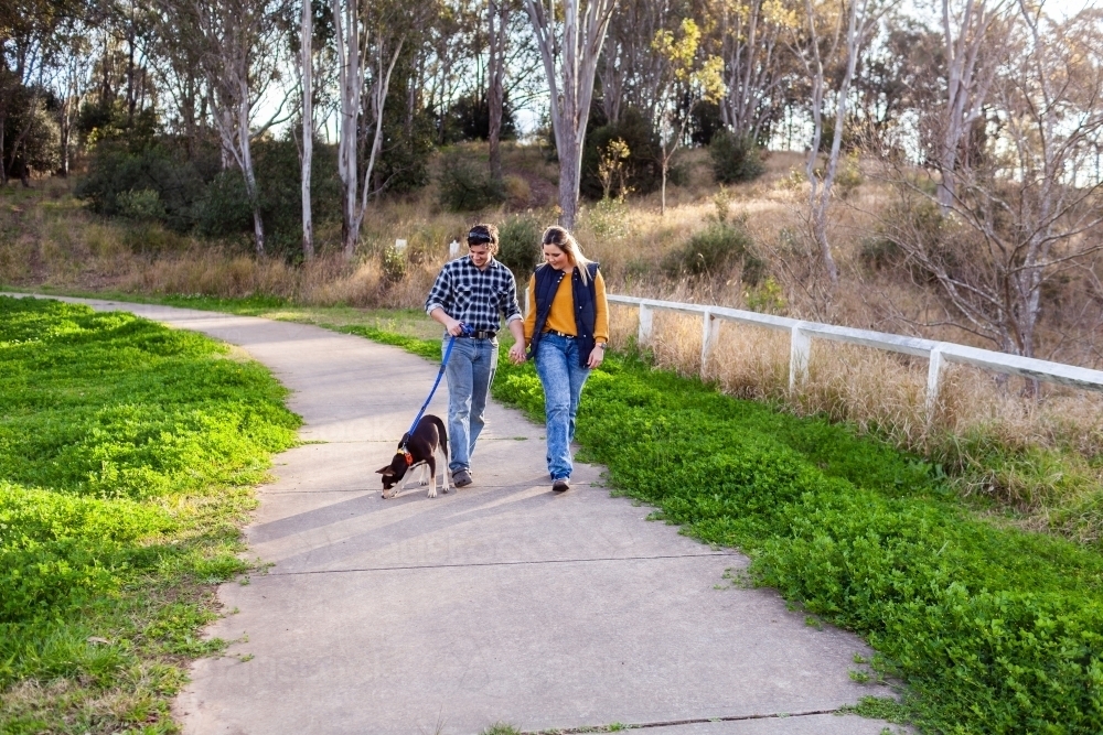 Image of Happy young couple in their twenties out walking their ...