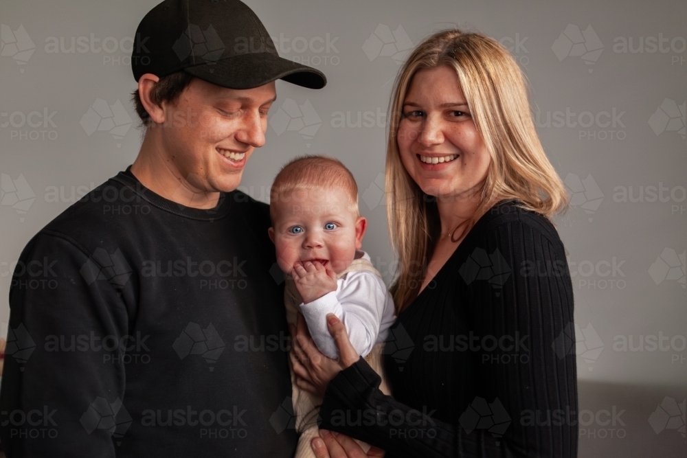 Image of Happy young parents with their first child together inside ...