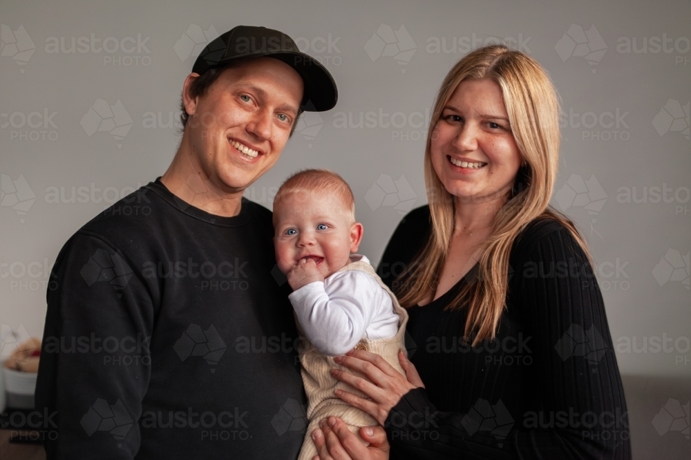 Image of Happy young parents with their first child together inside ...