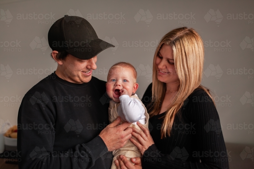 Image of Happy young parents with their first child together inside ...
