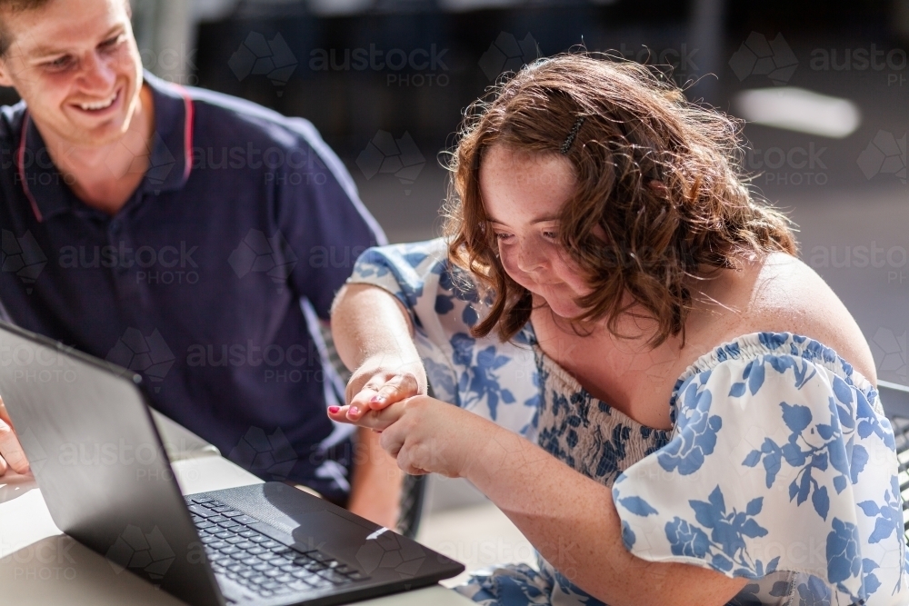 Image of Happy young person with a disability using hands to talk in ...