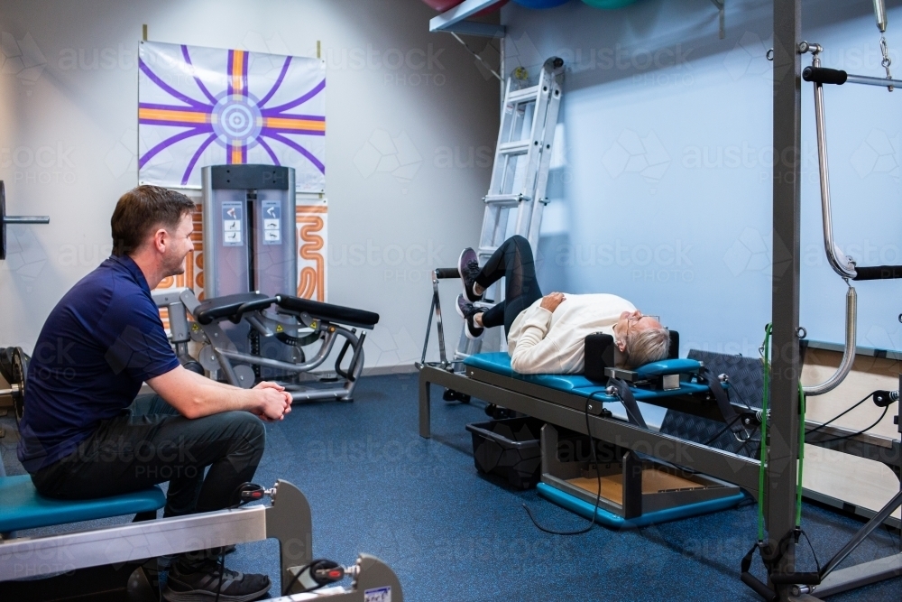 Image of happy young physiotherapist working with female client on ...