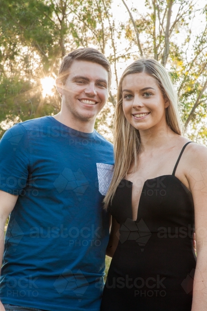 Image of Happy young teen couple standing together in the afternoon ...